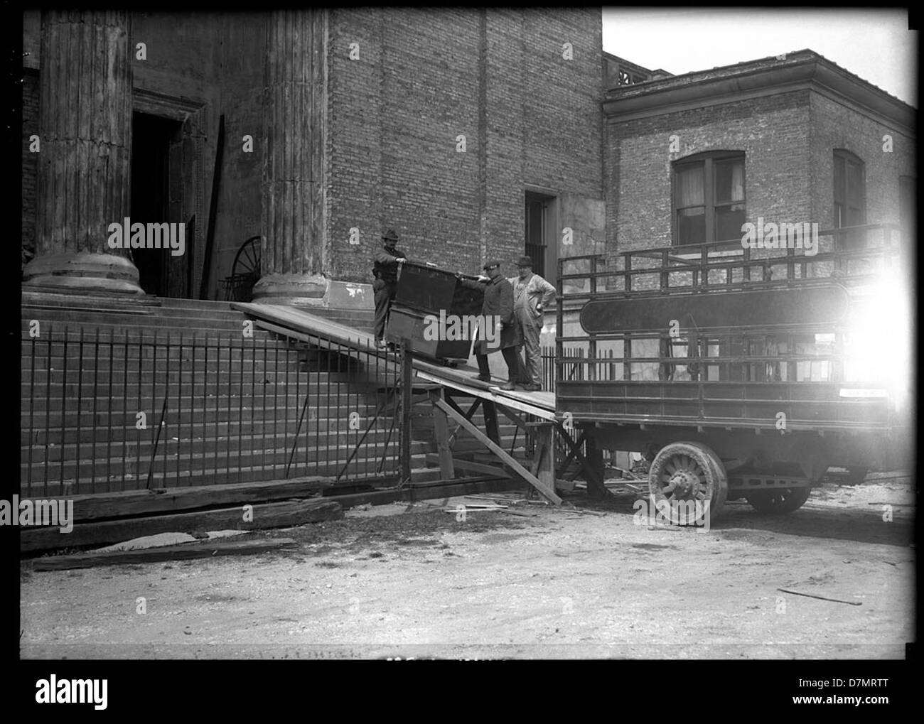 Museum staff moving exhibit cases and crates onto a truck, part of the ...