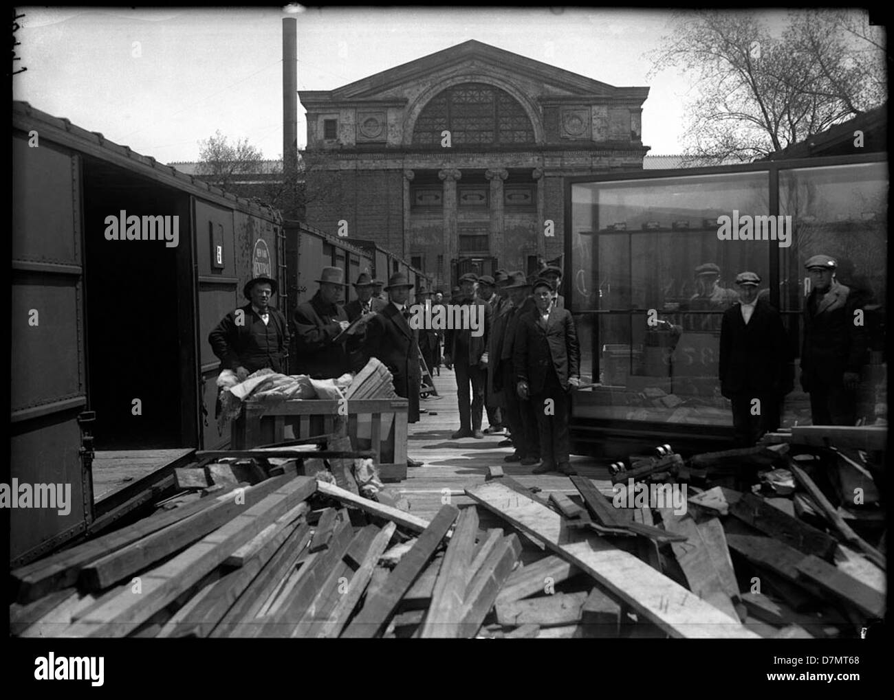A photograph of men handling exhibit cases on a loading dock during the ...