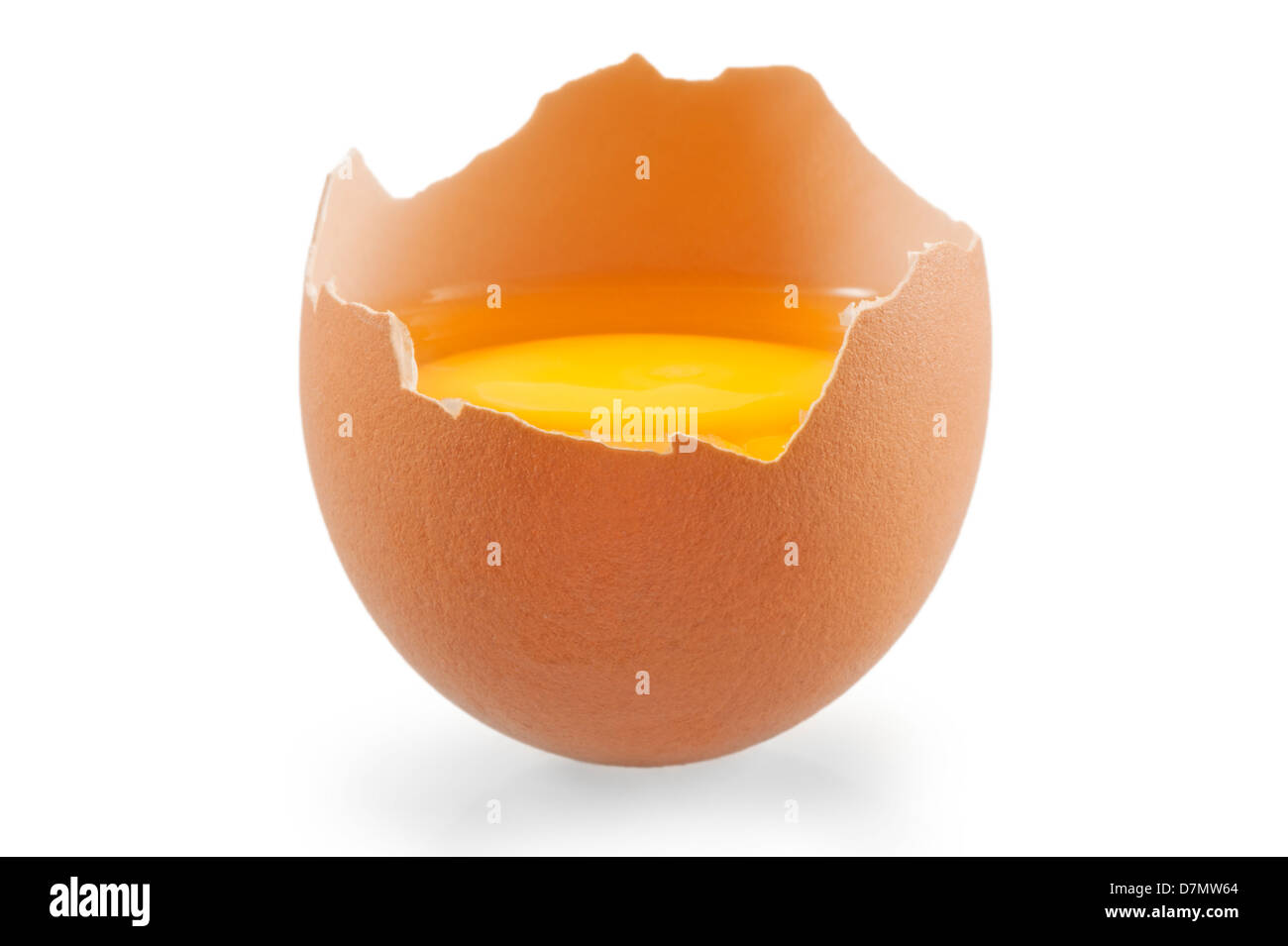 close up on a broken raw eggs, one whole isolated on white background ...