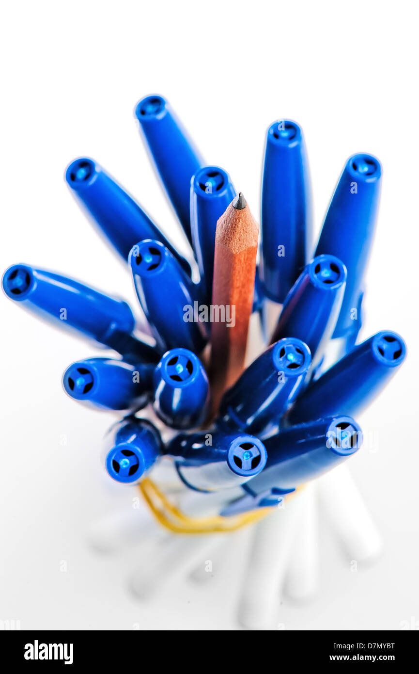Sharpened pencil between pens in caps Stock Photo - Alamy