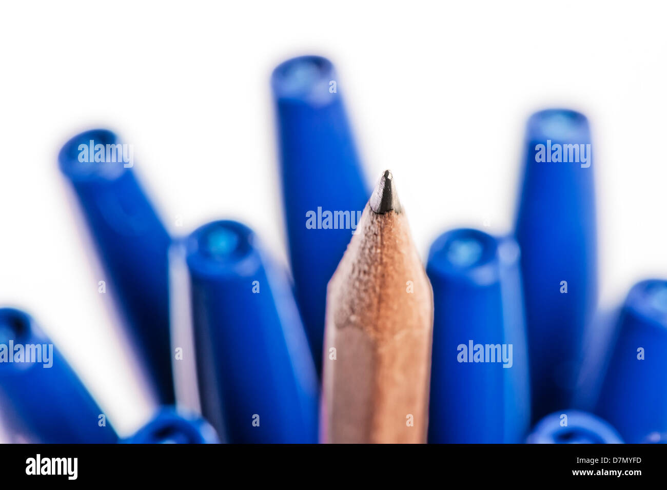 Sharpened pencil between pens in caps Stock Photo - Alamy