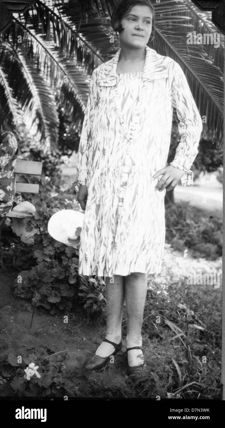A photograph of a woman posing in a garden, collecting fossils as part ...