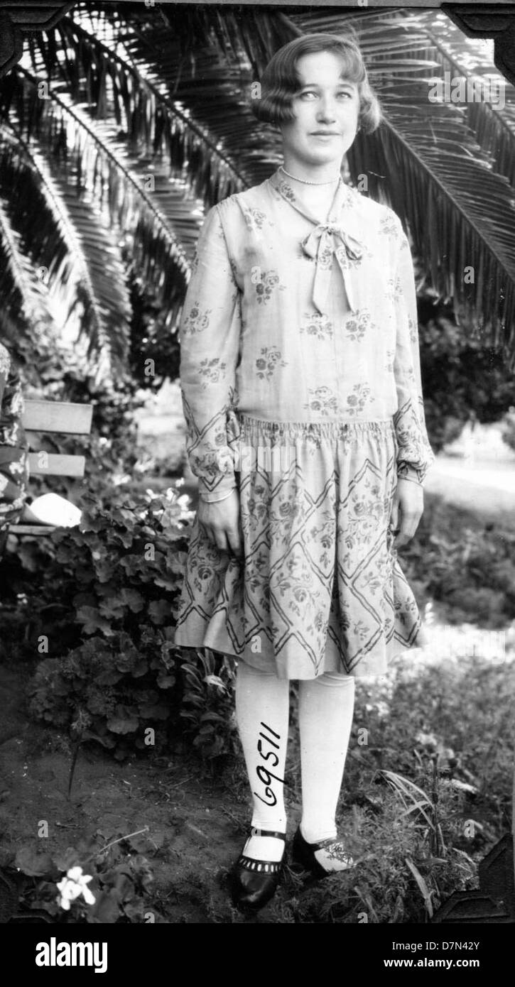 A photograph showing a woman in a garden, collecting fossils during the ...