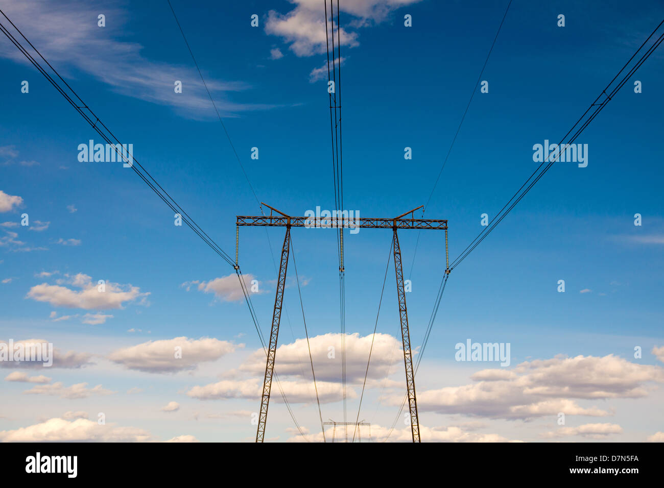 Power transmission lines and blue sky with clouds. Horizontal symmetry ...