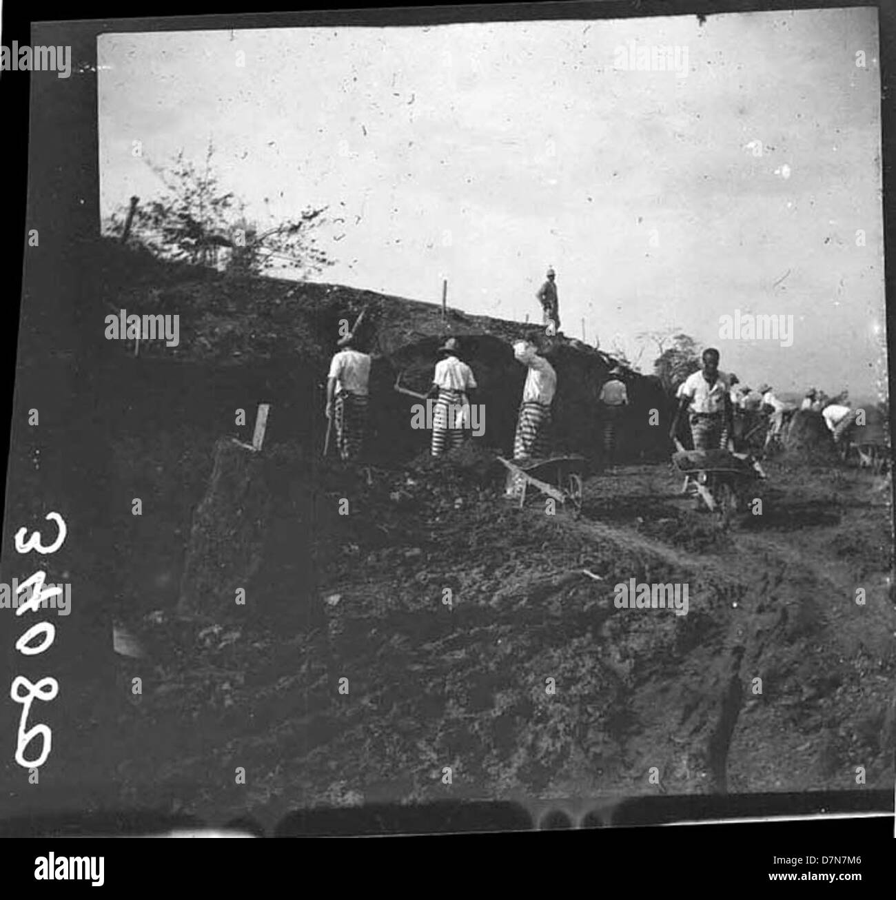 Men in striped pants digging Stock Photo - Alamy