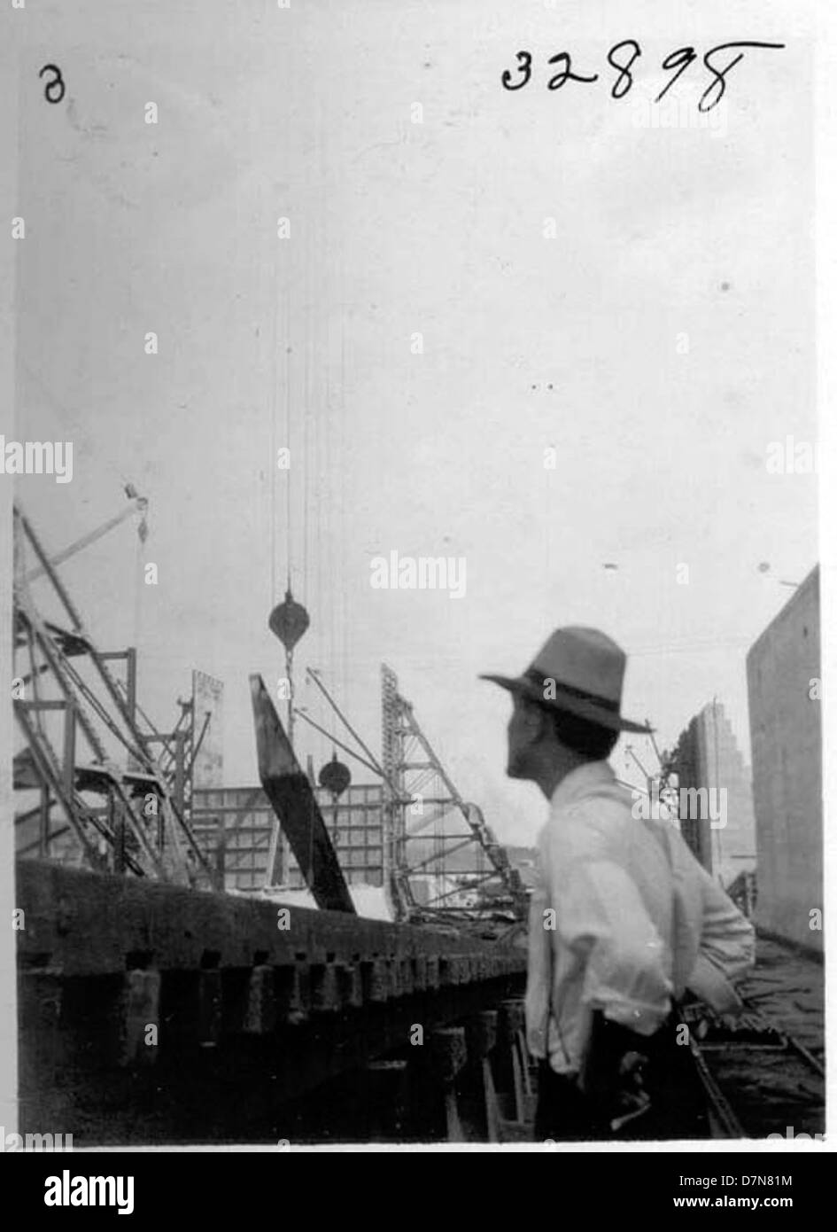 Man watching construction of cement lock wall Stock Photo - Alamy