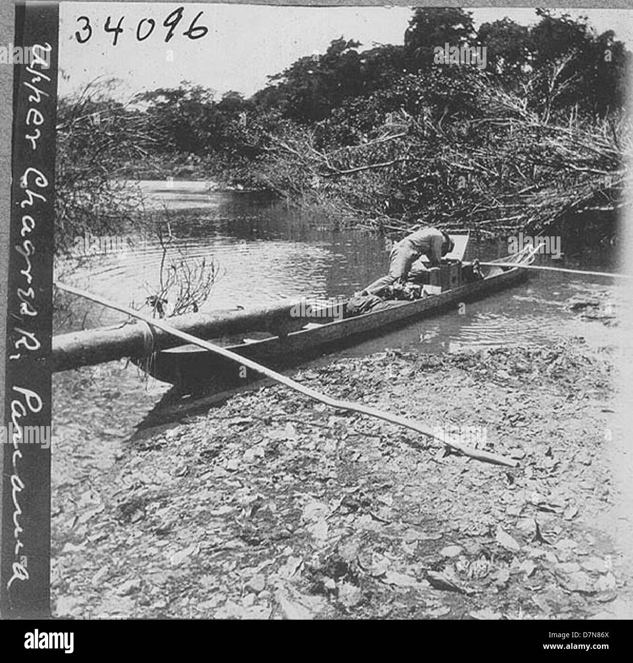 The image features a man in a dugout canoe, likely captured during the ...