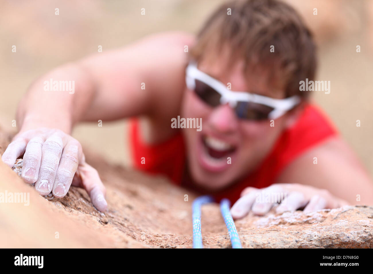 Climbing challenge. Man climber using all strength, focus and courage ...