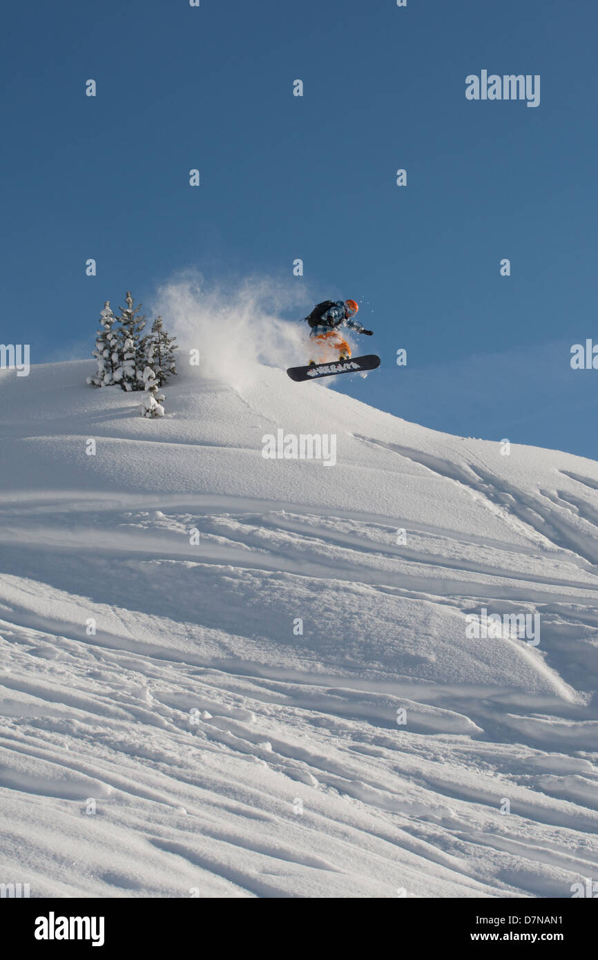 Snowboarder enjoying powder late in the afternoon in Austria Stock ...