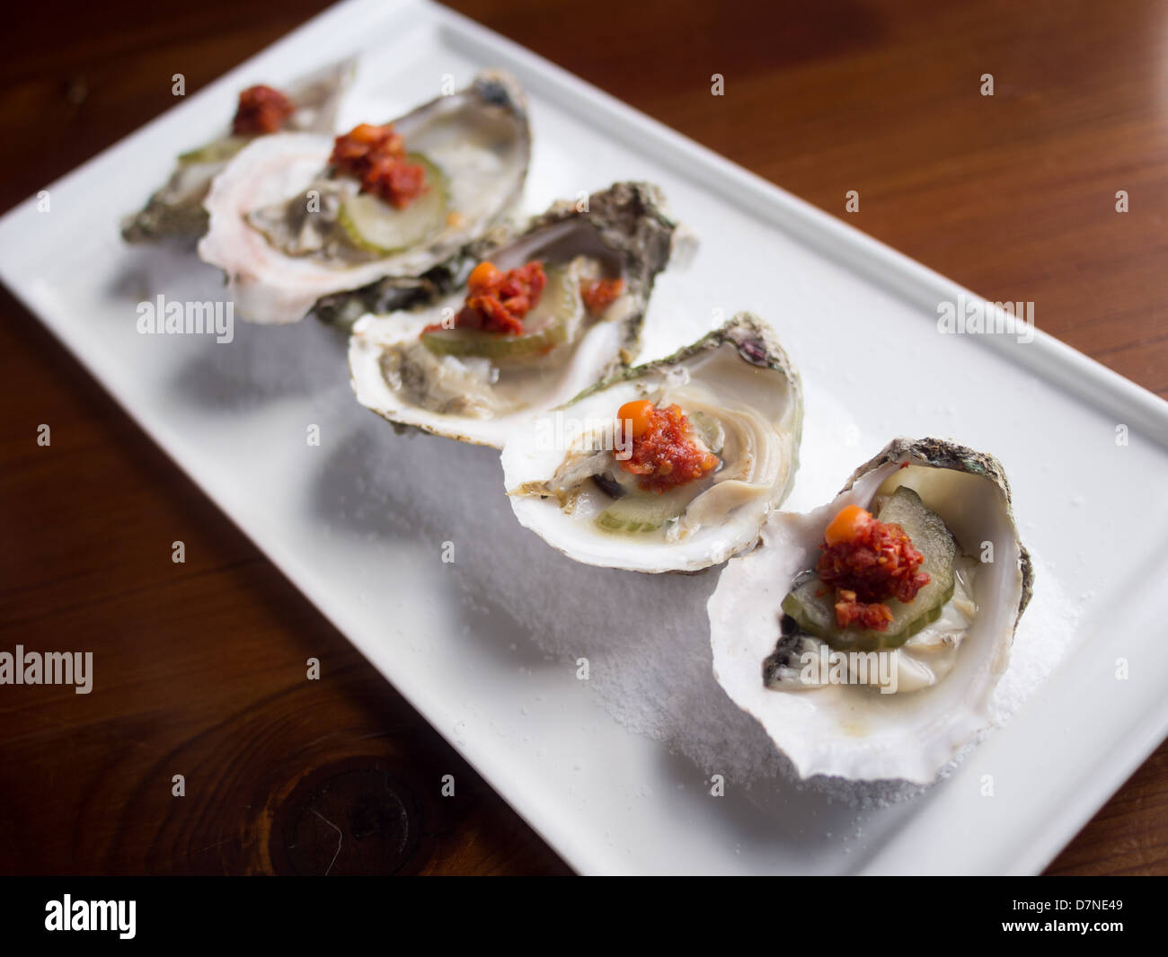 Dressed up fancy raw oysters on a half shell Stock Photo - Alamy