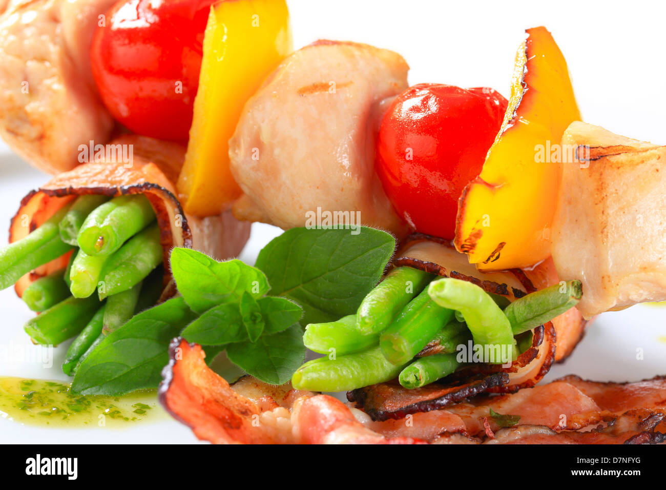 Chicken skewer and string beans wrapped in bacon Stock Photo - Alamy