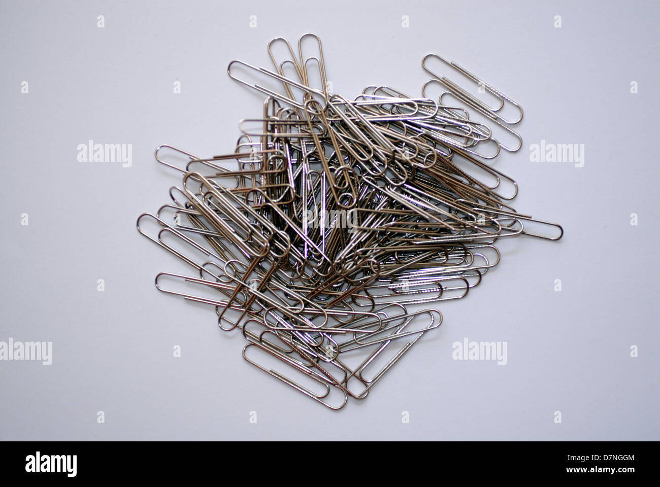 Pile of metal paper clips on white background Stock Photo - Alamy