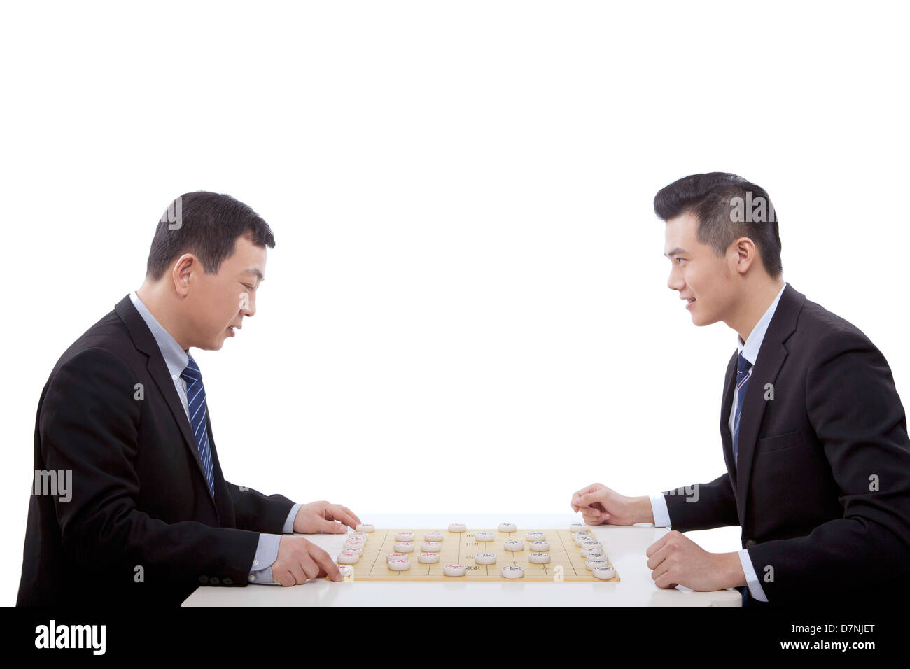 Two business men playing Chinese chess Stock Photo - Alamy