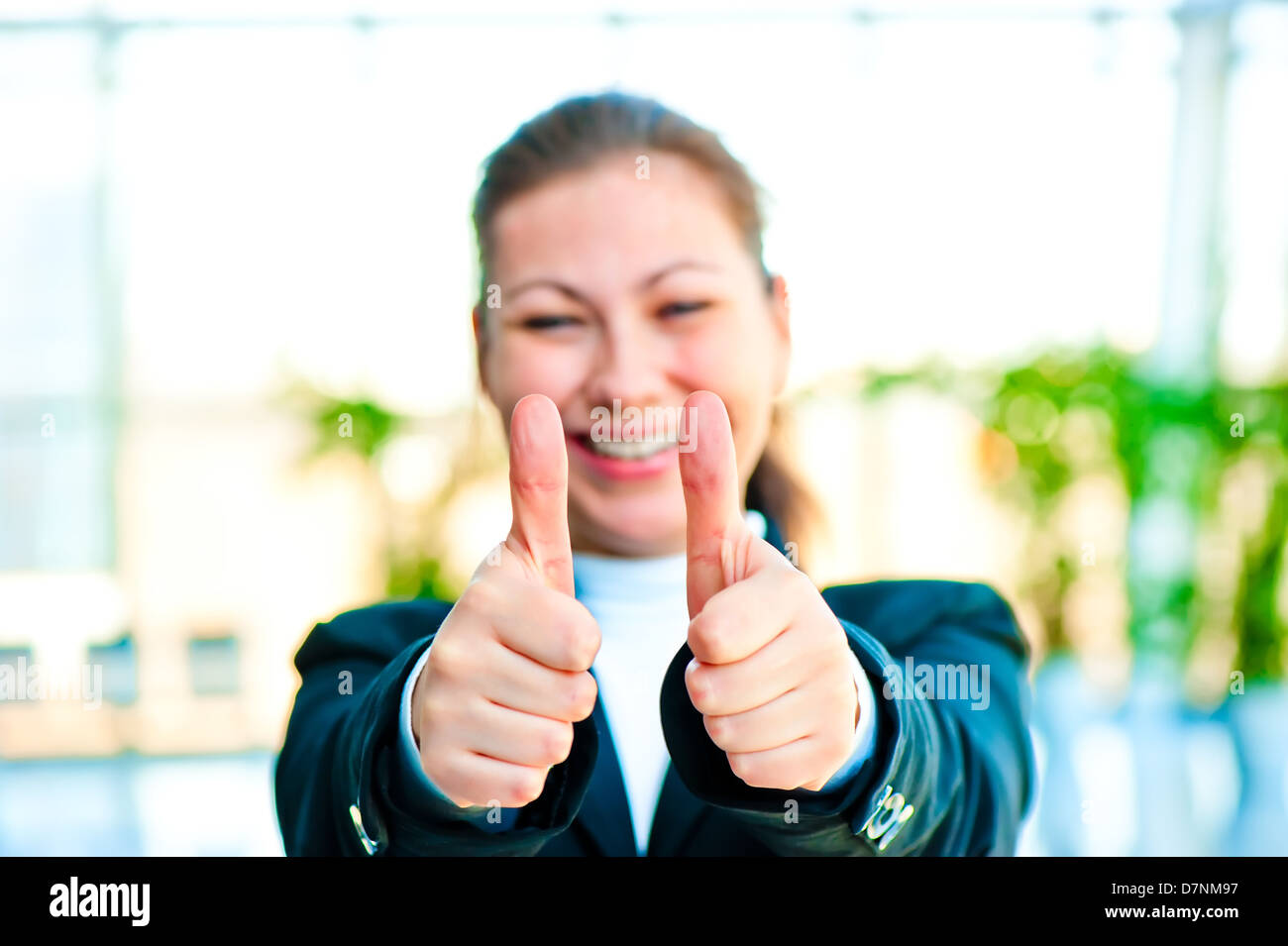 Girl in a business suit shows that everything is fine Stock Photo - Alamy