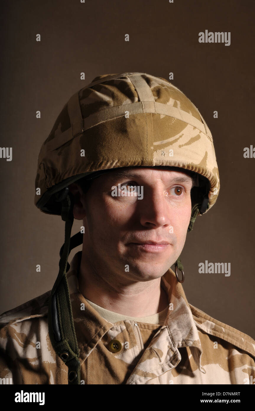 Portrait of a soldier with blank expression on his face against a dark ...