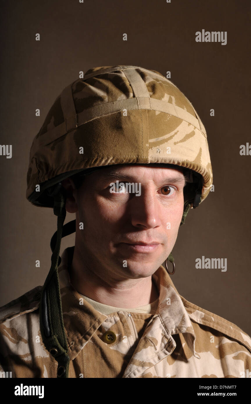 Portrait of a soldier with blank expression on his face against a dark ...