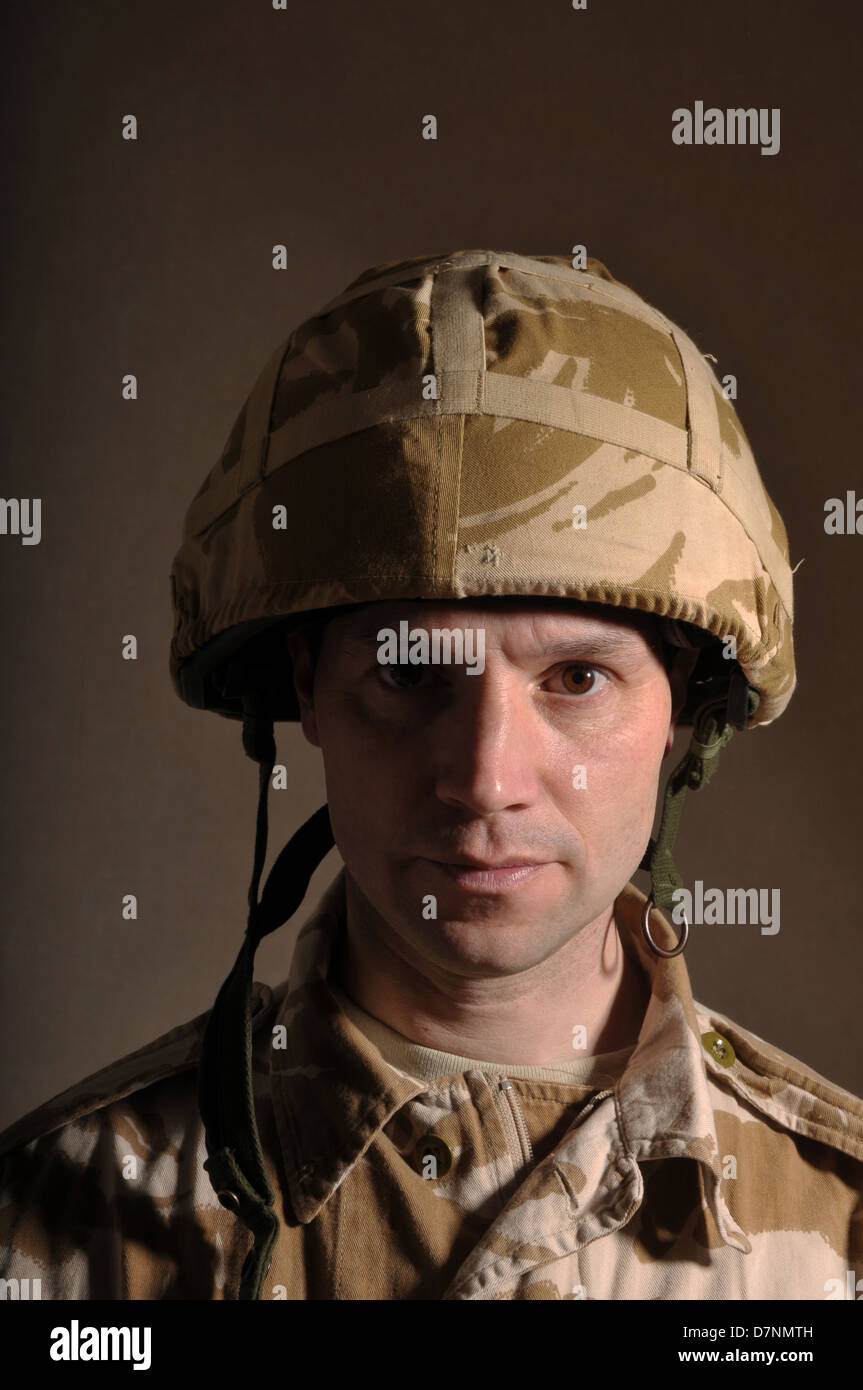 Portrait of a soldier with blank expression on his face against a dark ...