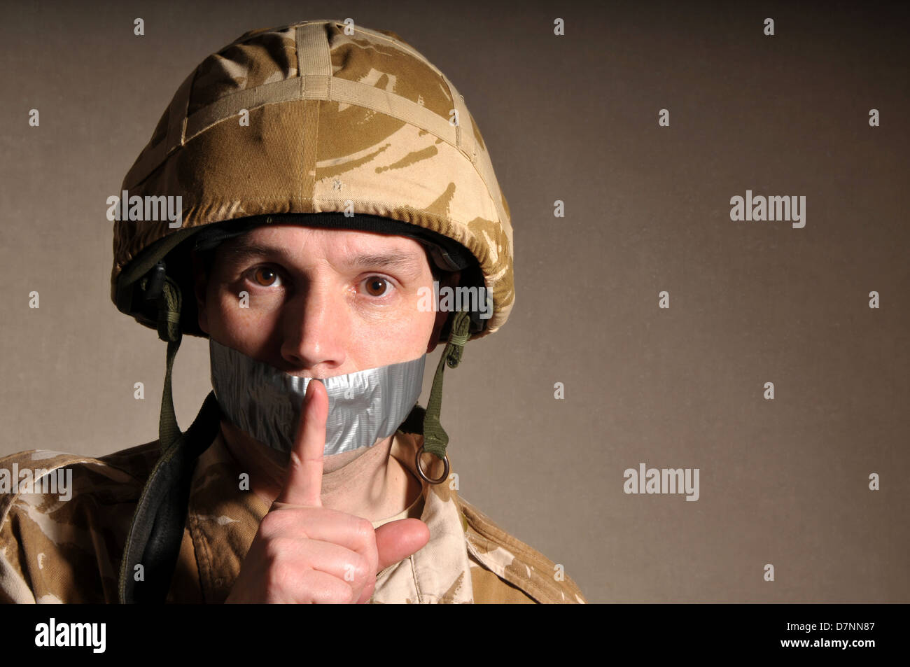 British soldier with his mouth taped and making a hand gesture for ...