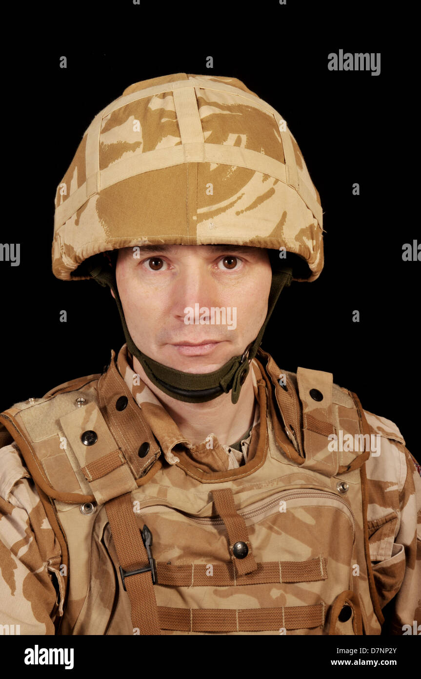Portrait of a soldier wearing British Military uniform, against a black ...