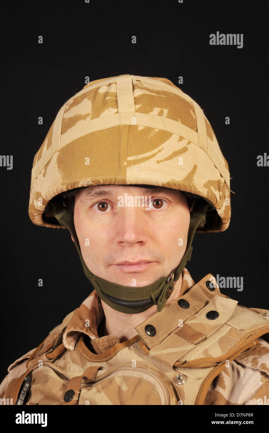 Portrait of a soldier wearing British Military uniform, against a black ...