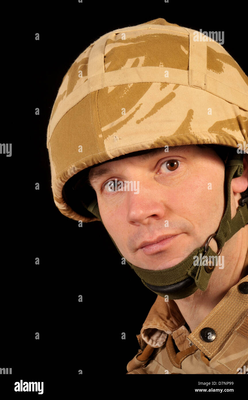 Portrait of a soldier wearing British Military uniform, against a black ...
