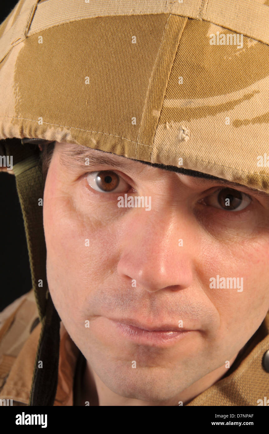 Portrait of a soldier wearing British Military uniform, against a black ...