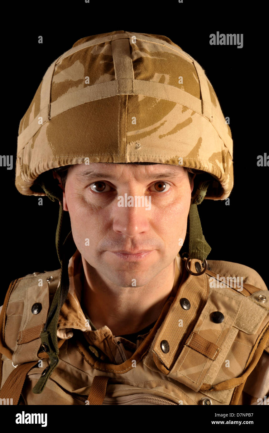 Portrait of a soldier wearing British Military uniform, against a black ...