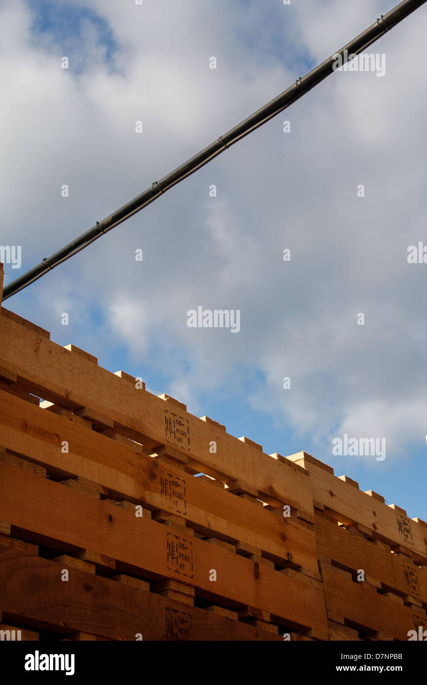 Pallets stacked in the proximity of an overhead cable Stock Photo - Alamy
