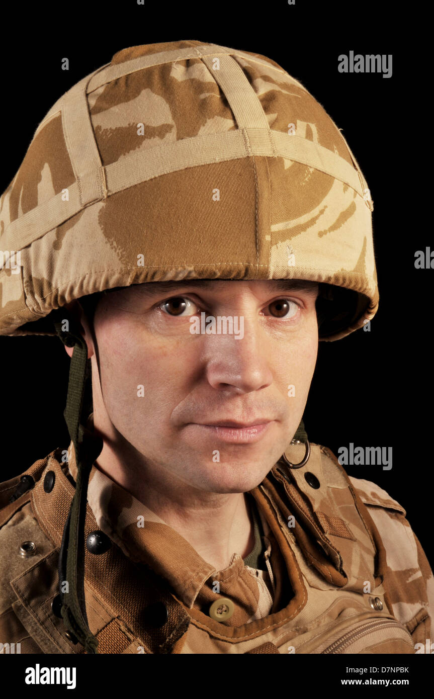 Portrait of a soldier wearing British Military uniform, against a black ...