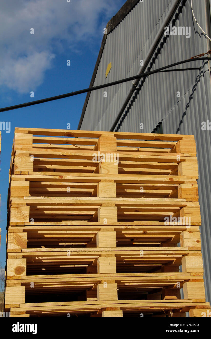 Pallets stacked in the proximity of an overhead cable Stock Photo - Alamy