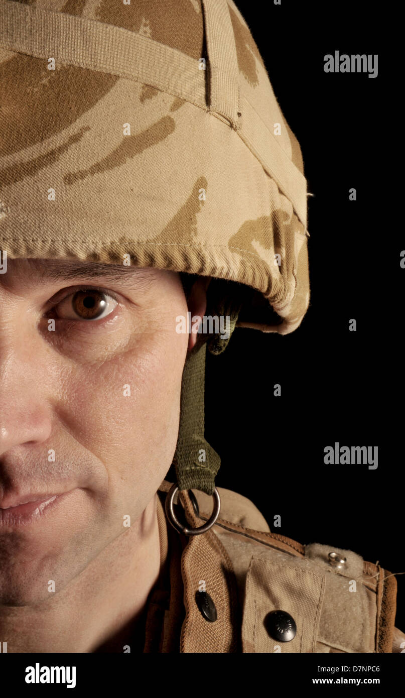 Half face portrait of a British soldier wearing desert camouflage ...