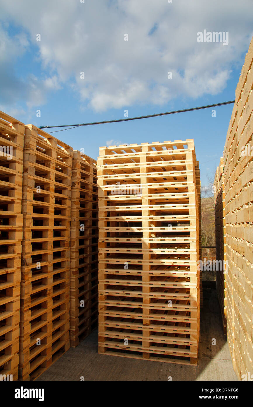 Pallets stacked in the proximity of an overhead cable Stock Photo - Alamy