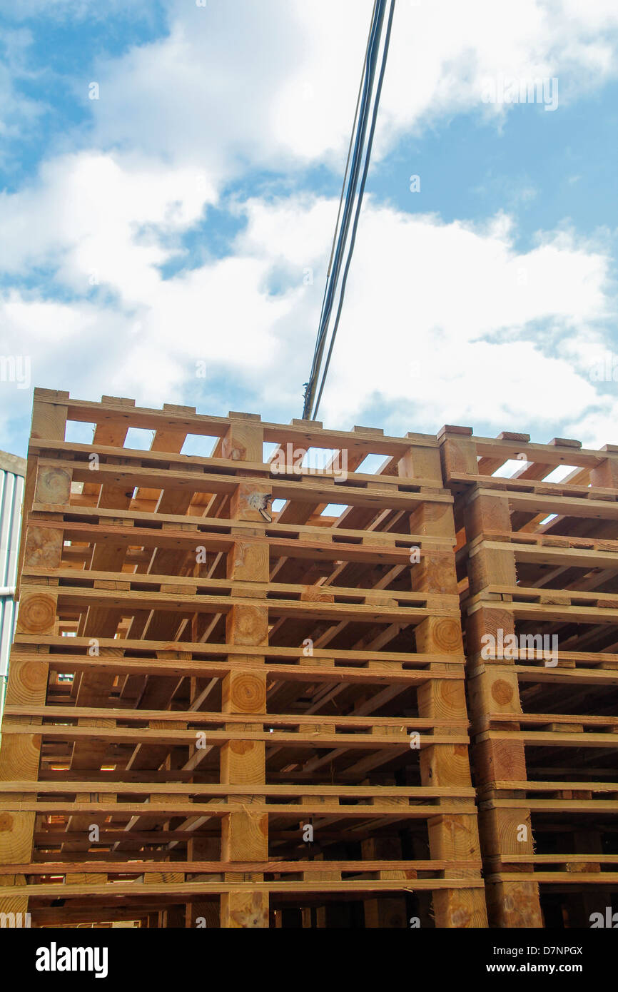 Pallets stacked in the proximity of an overhead cable Stock Photo - Alamy