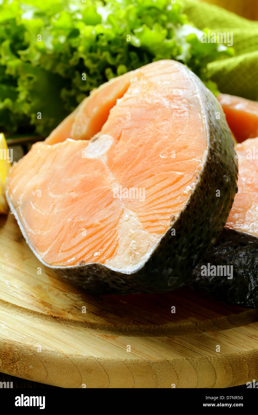 fresh raw red fish (salmon) on a cutting board Stock Photo - Alamy