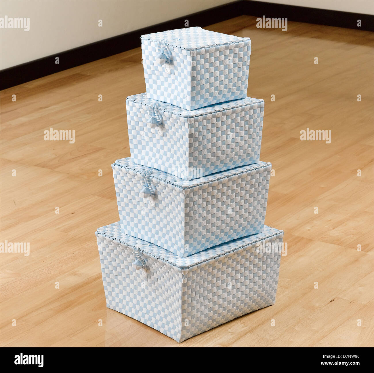 Stack of weaved plastic basket from biggest to smallest Stock Photo - Alamy