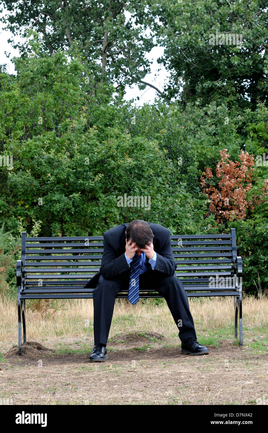 Depressed Man Sitting On Park Bench Stock Photos & Depressed Man ...