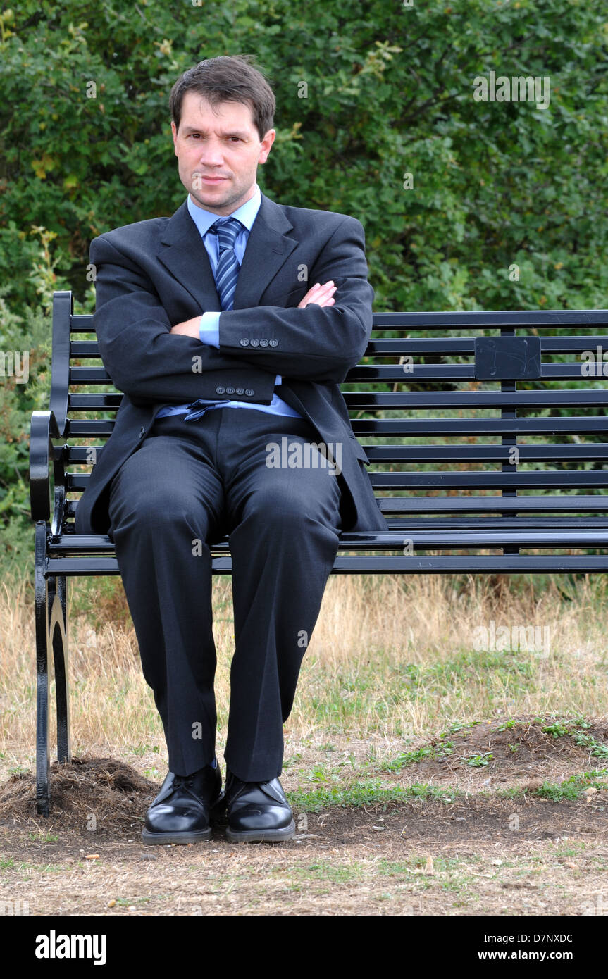 Man Sitting On Bench In Suit