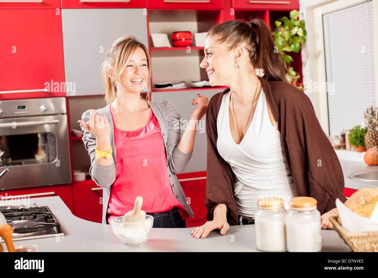 Two girls in the kitchen Stock Photo - Alamy