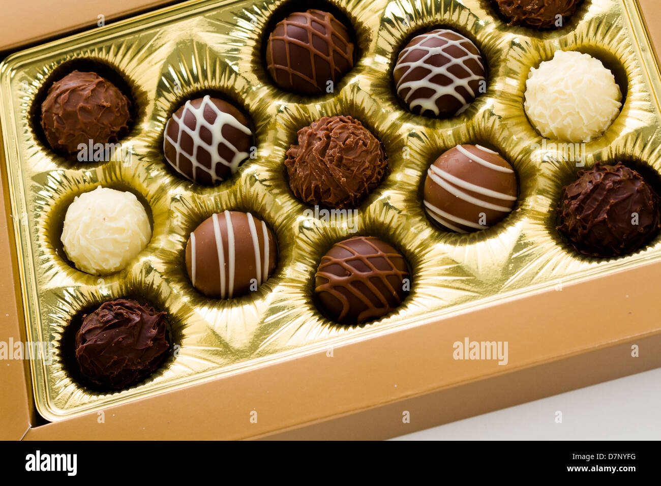 Box of assorted gourmet truffles on a white background Stock Photo - Alamy