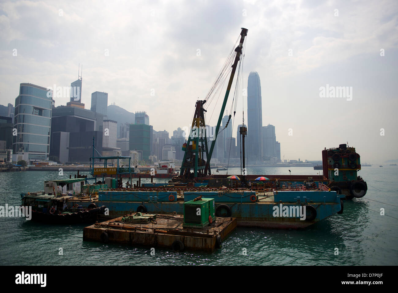 Construction barge in the harbour near Wan Chai. View of Central in the ...