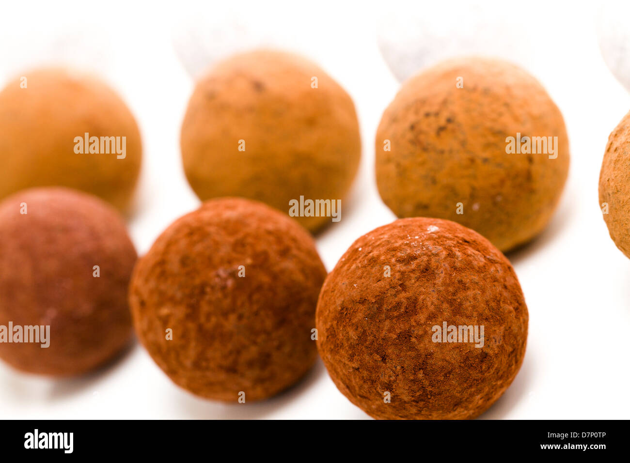 Assorted gourmet truffles on a white background Stock Photo - Alamy