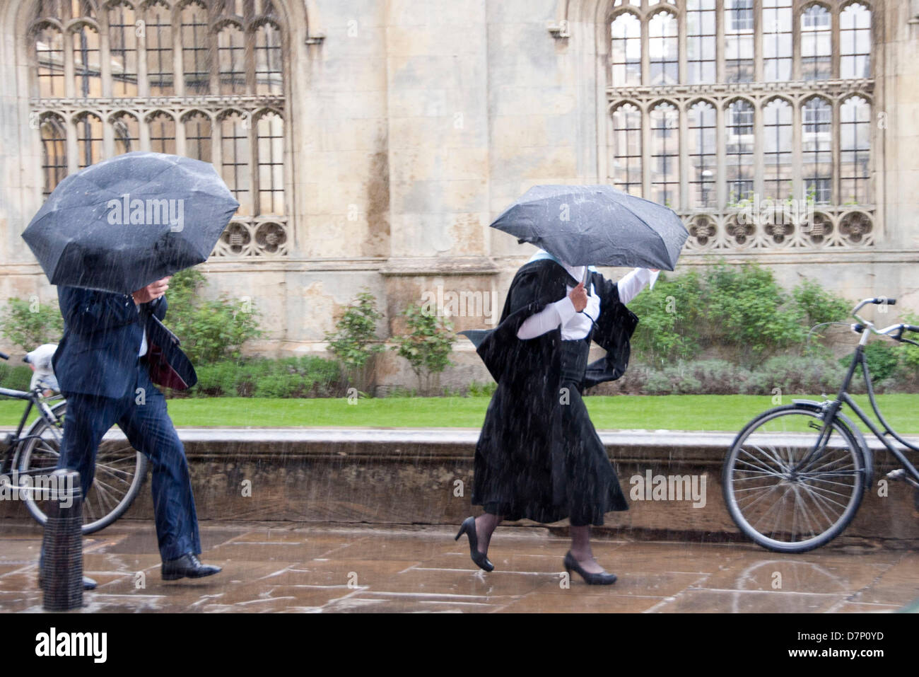 Cambridge, UK. 11th May 2013. Graduates get soaked by torrential rain ...