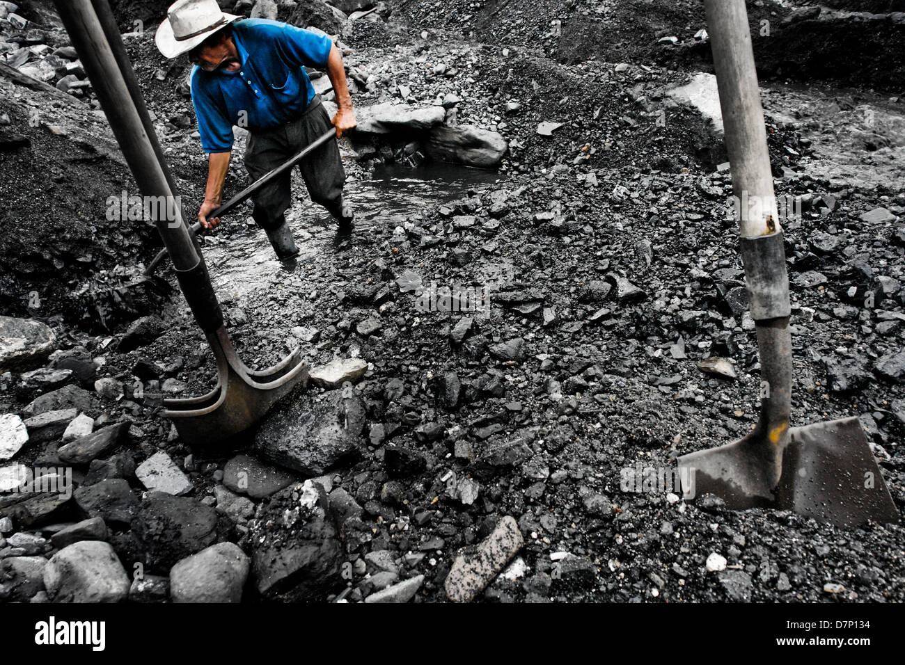 A miner searches for emeralds in the mine of Muzo, Colombia Stock Photo ...