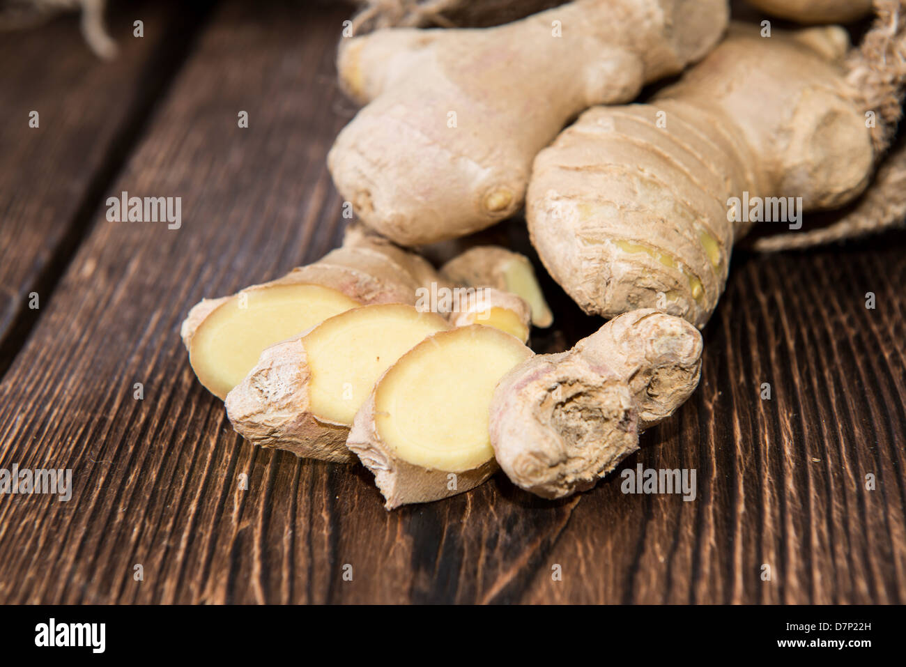 Fresh pieces of Ginger (macro shot) on wooden background Stock Photo ...