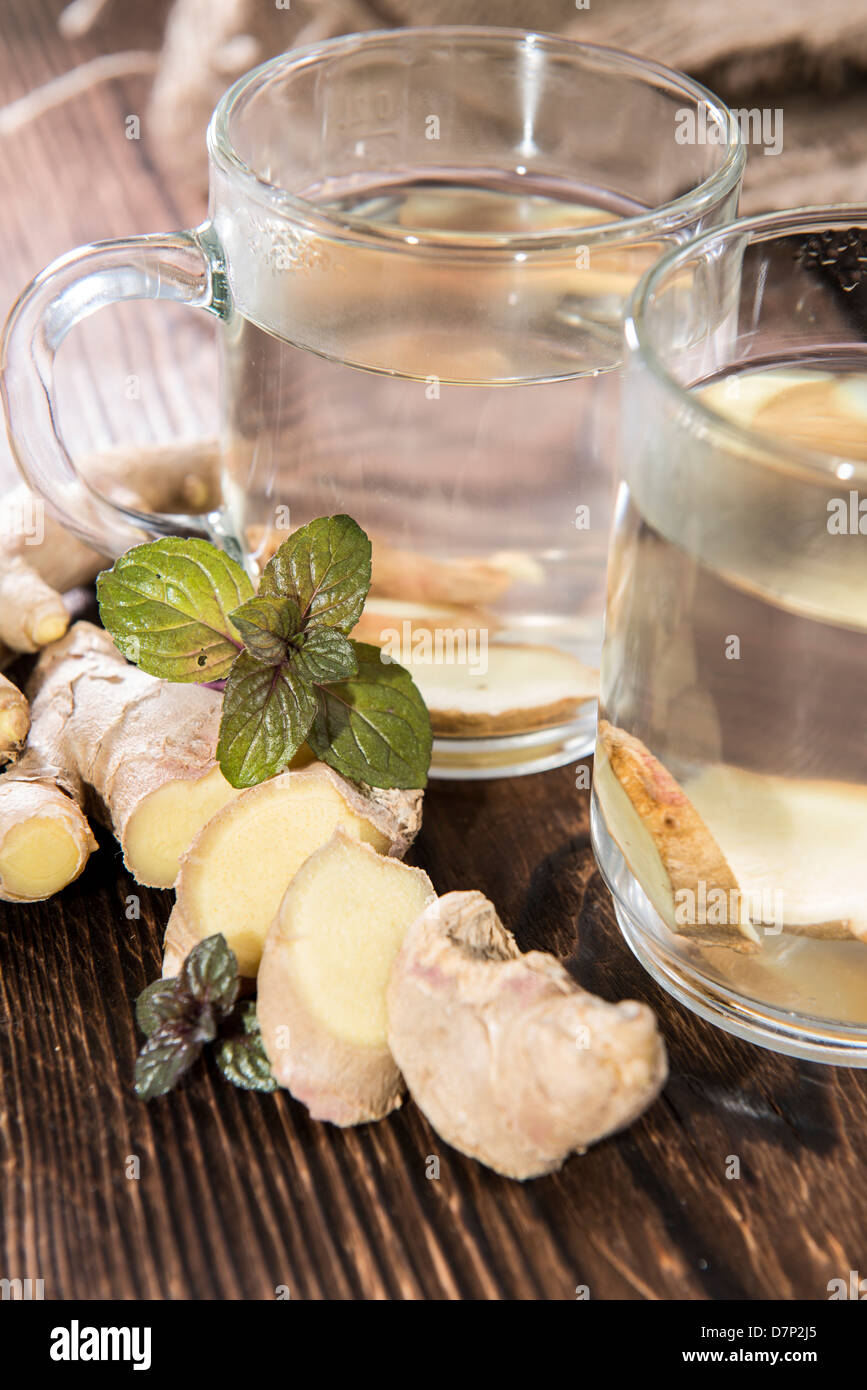 Homemade portion of fresh Ginger Tea on wooden background Stock Photo ...