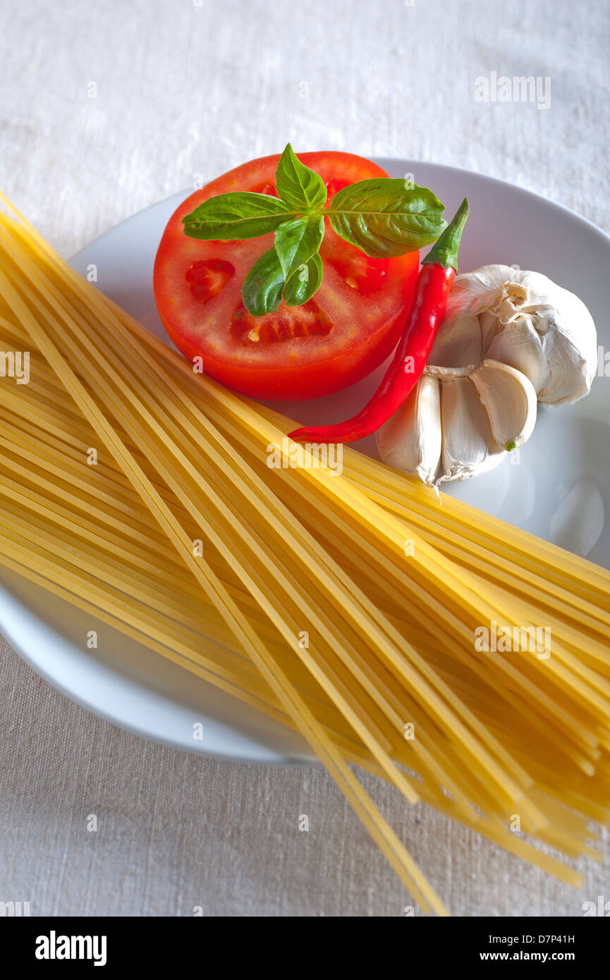 Italian spaghetti pasta tomato raw ingredients basil garlic and red ...