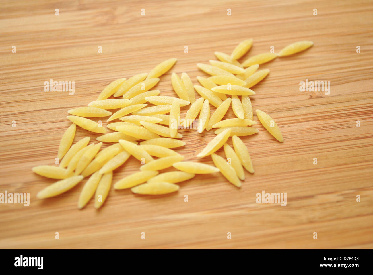 Risoni Pasta on a Wood Background Stock Photo - Alamy