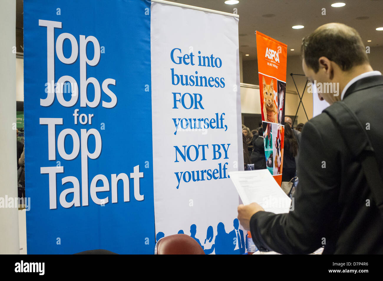 Job seekers attend a job fair at the Jacob Javits Convention Center in ...