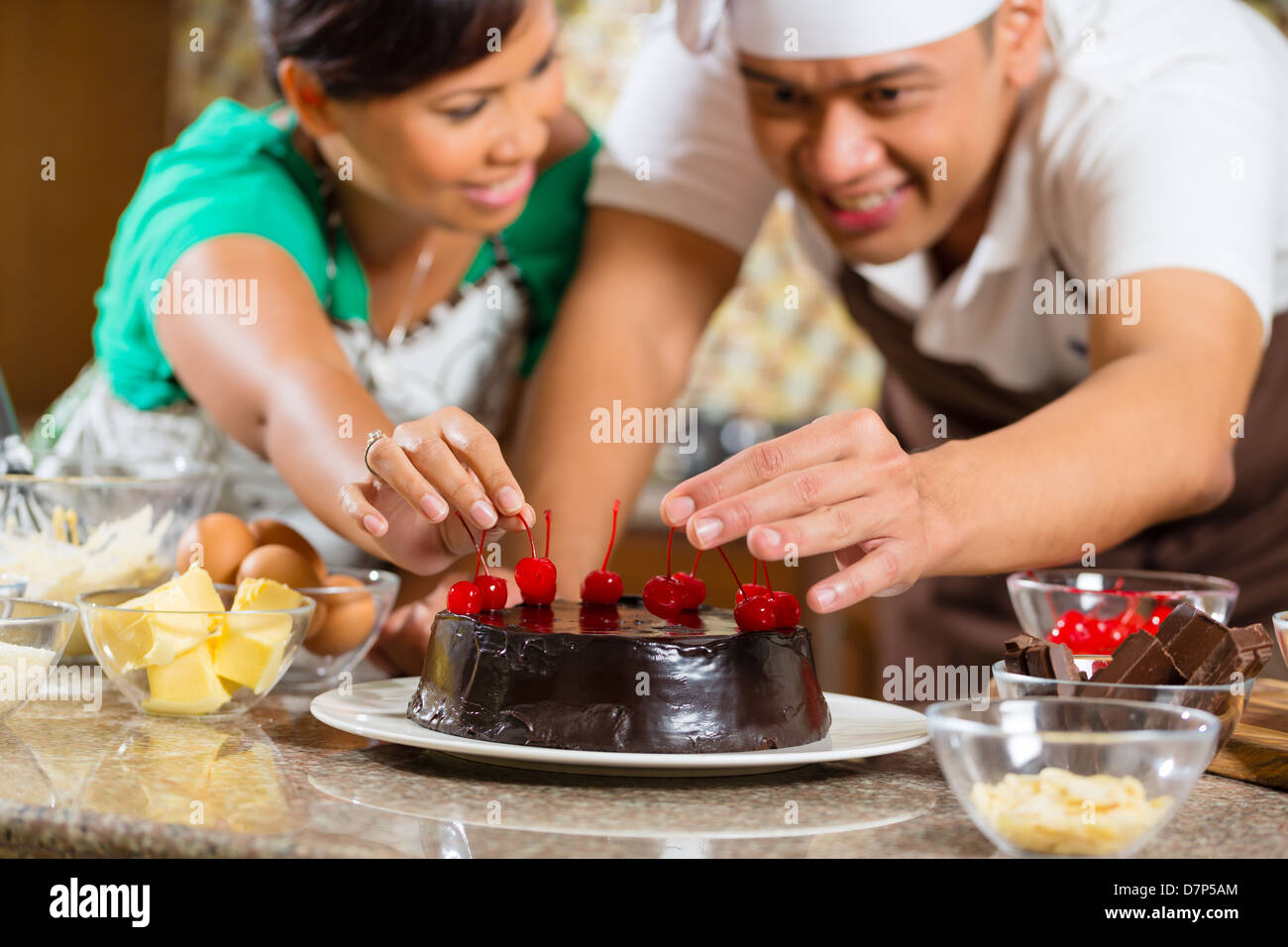 Asian couple baking cake hi-res stock photography and images - Alamy