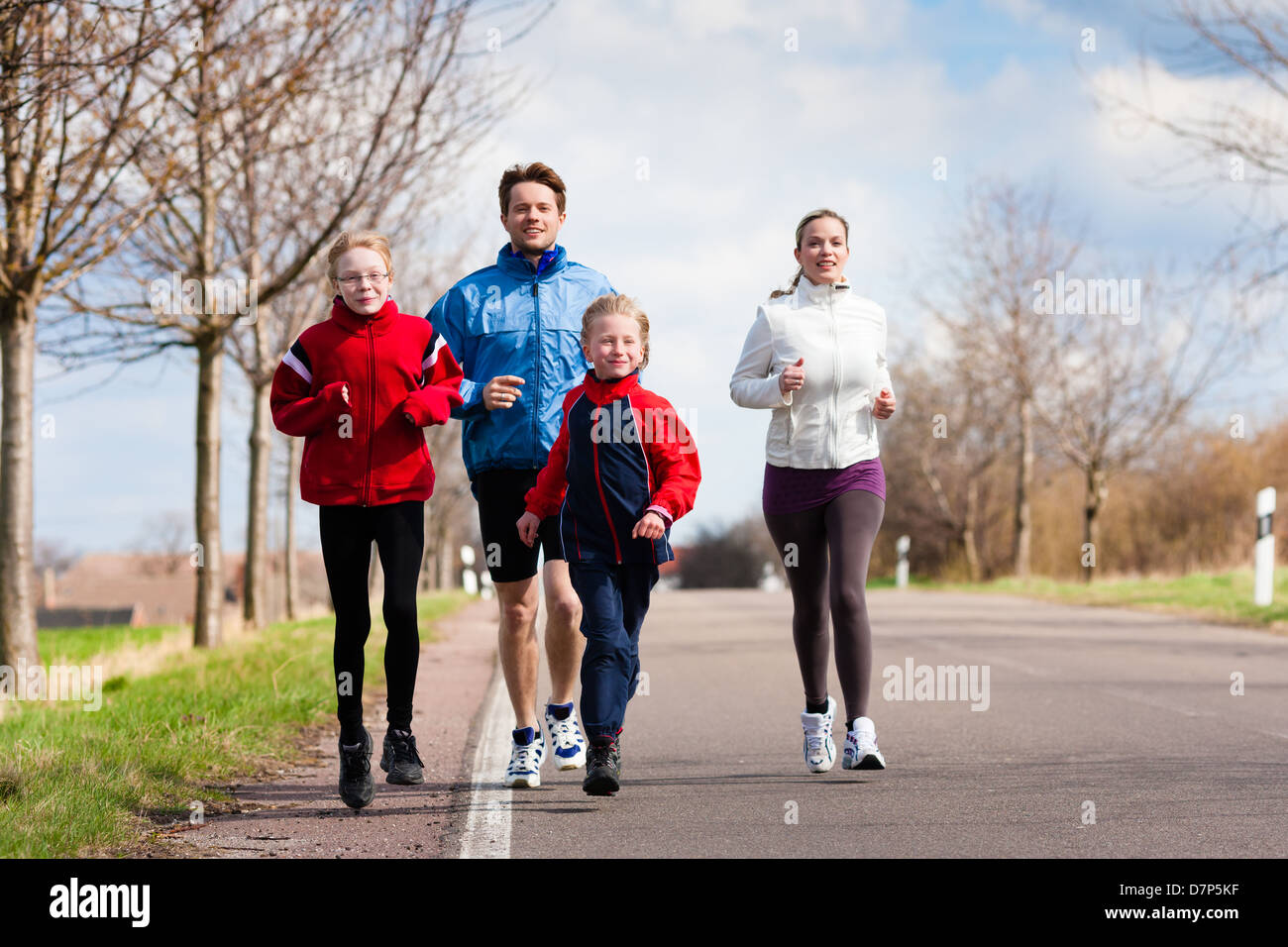 Family, mother, father and children are running or jogging for sport ...